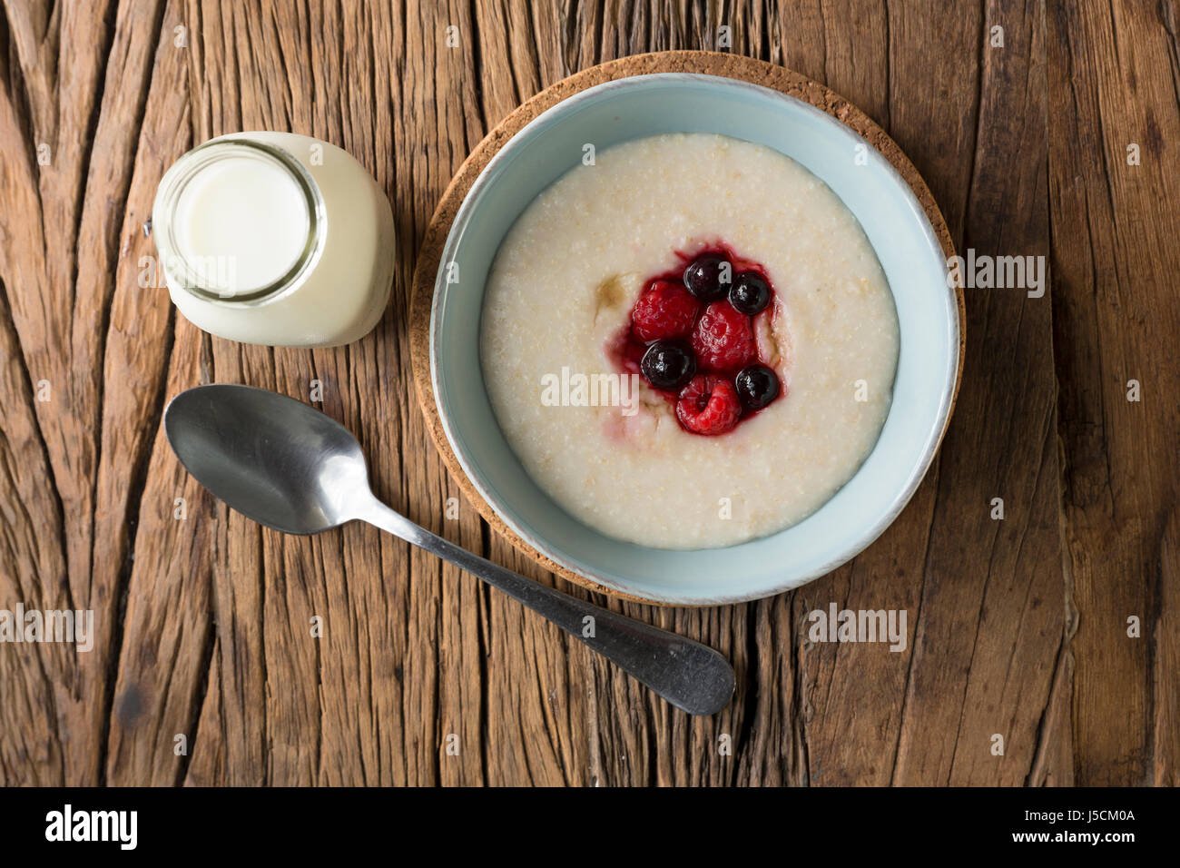 Freshly cooked porridge on a rustic wooden background Stock Photo - Alamy