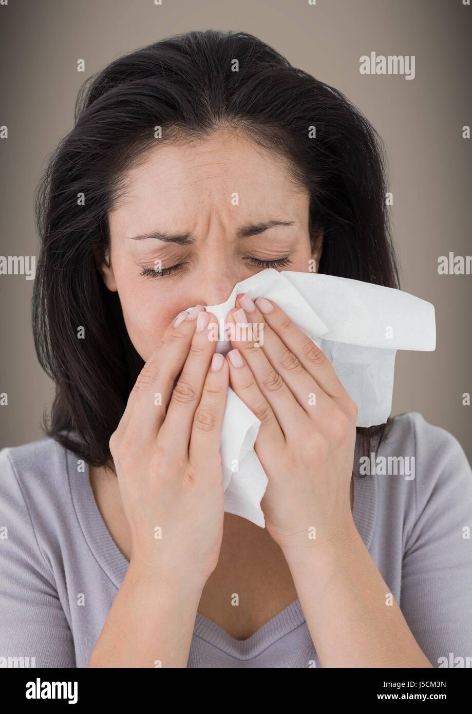 Digital composite of Woman crying into tissue against brown background ...