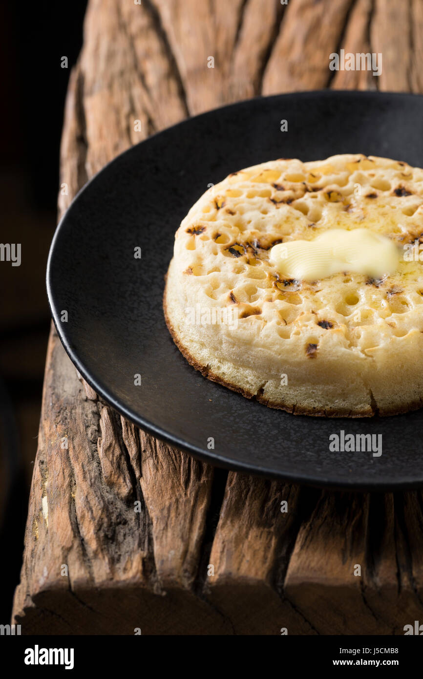 Toasted crumpets on a rustic wooden table Stock Photo - Alamy