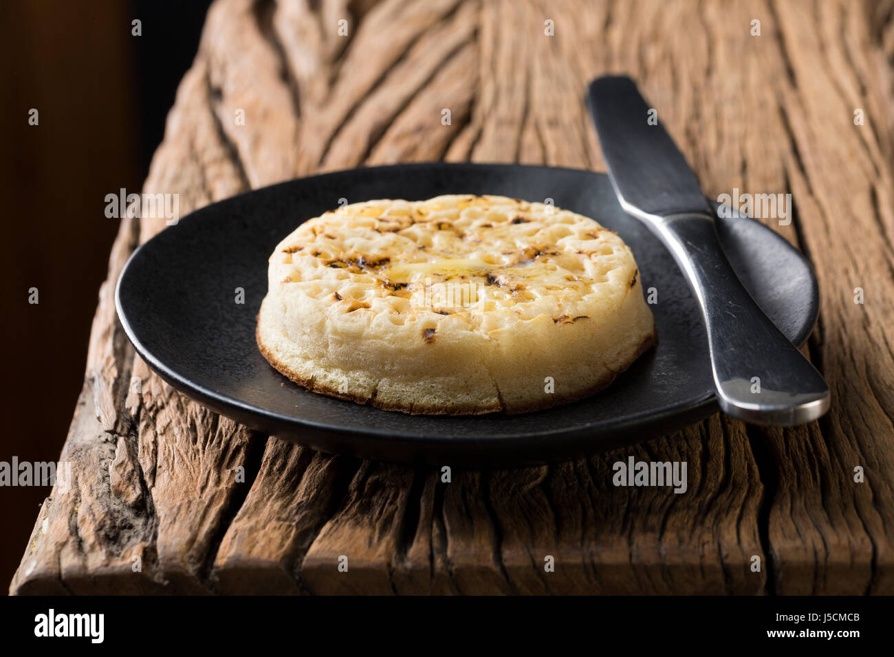 Toasted crumpets on a rustic wooden table Stock Photo - Alamy