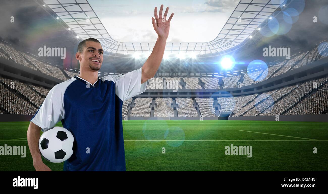 Digital composite of Soccer player with ball waving hand on field Stock ...