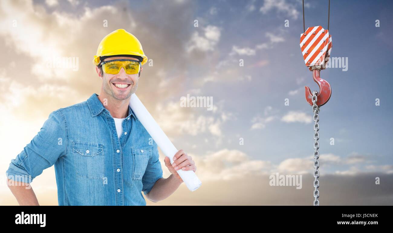 Digital composite of Smiling architect holding blueprints by crane hook ... Digital composite of Smiling architect holding blueprints by crane hook ...