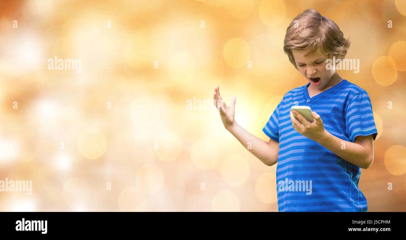 Digital composite of Angry boy holding mobile phone over blurred ...