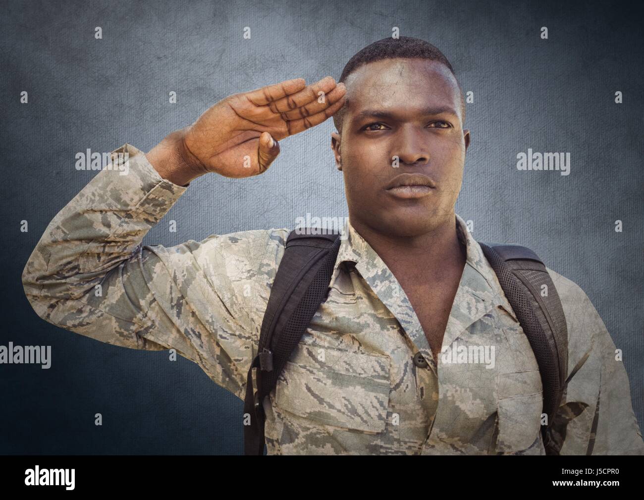 Digital composite of Soldier saluting against navy background with ...