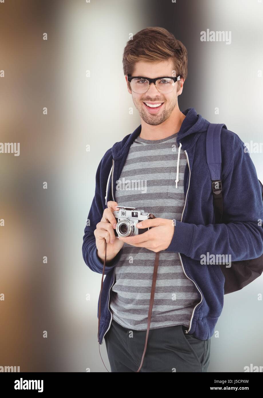 Digital composite of Portrait of happy male hipster holding camera ...