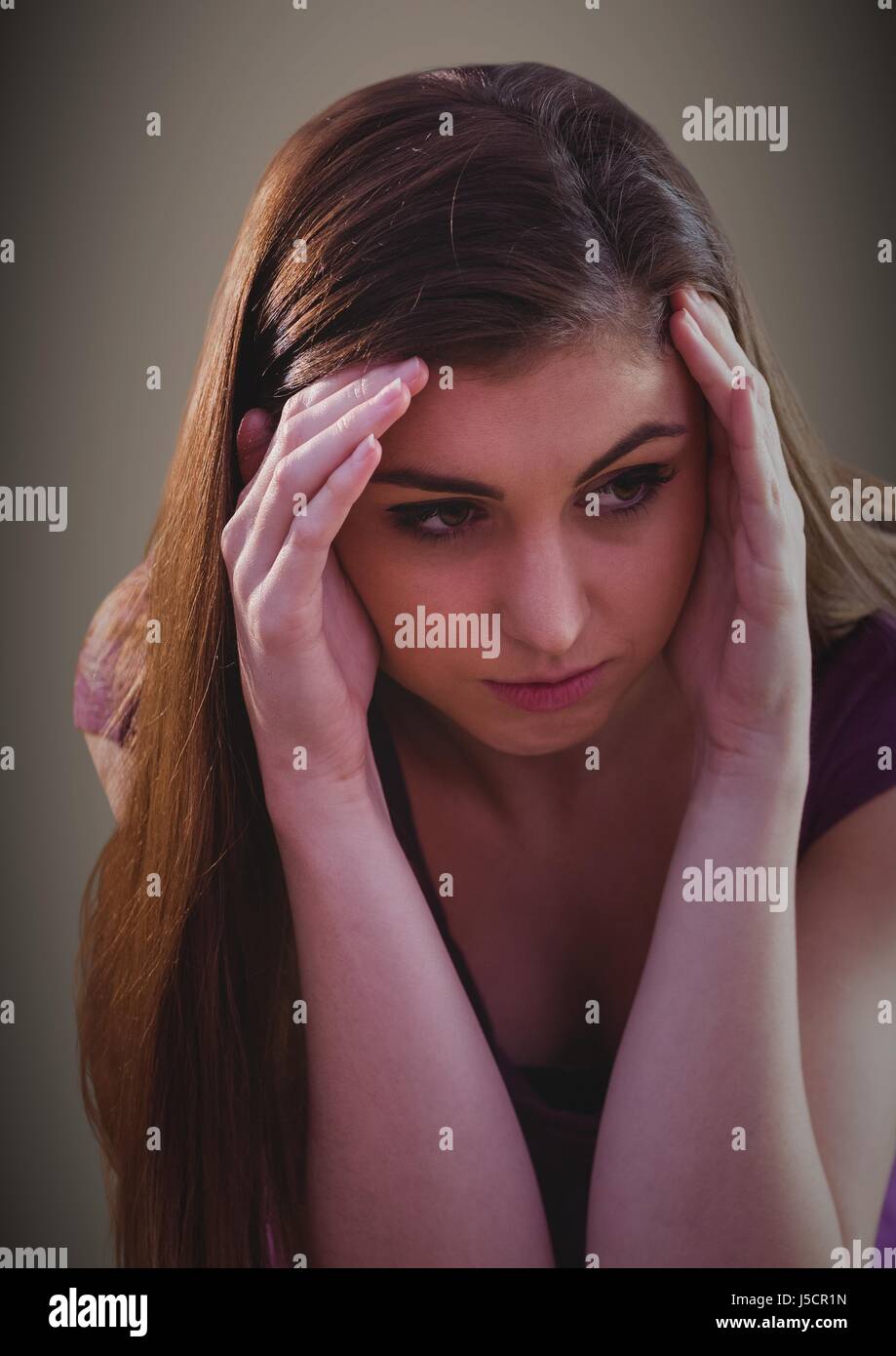 Digital composite of Woman hands around face against brown background ...