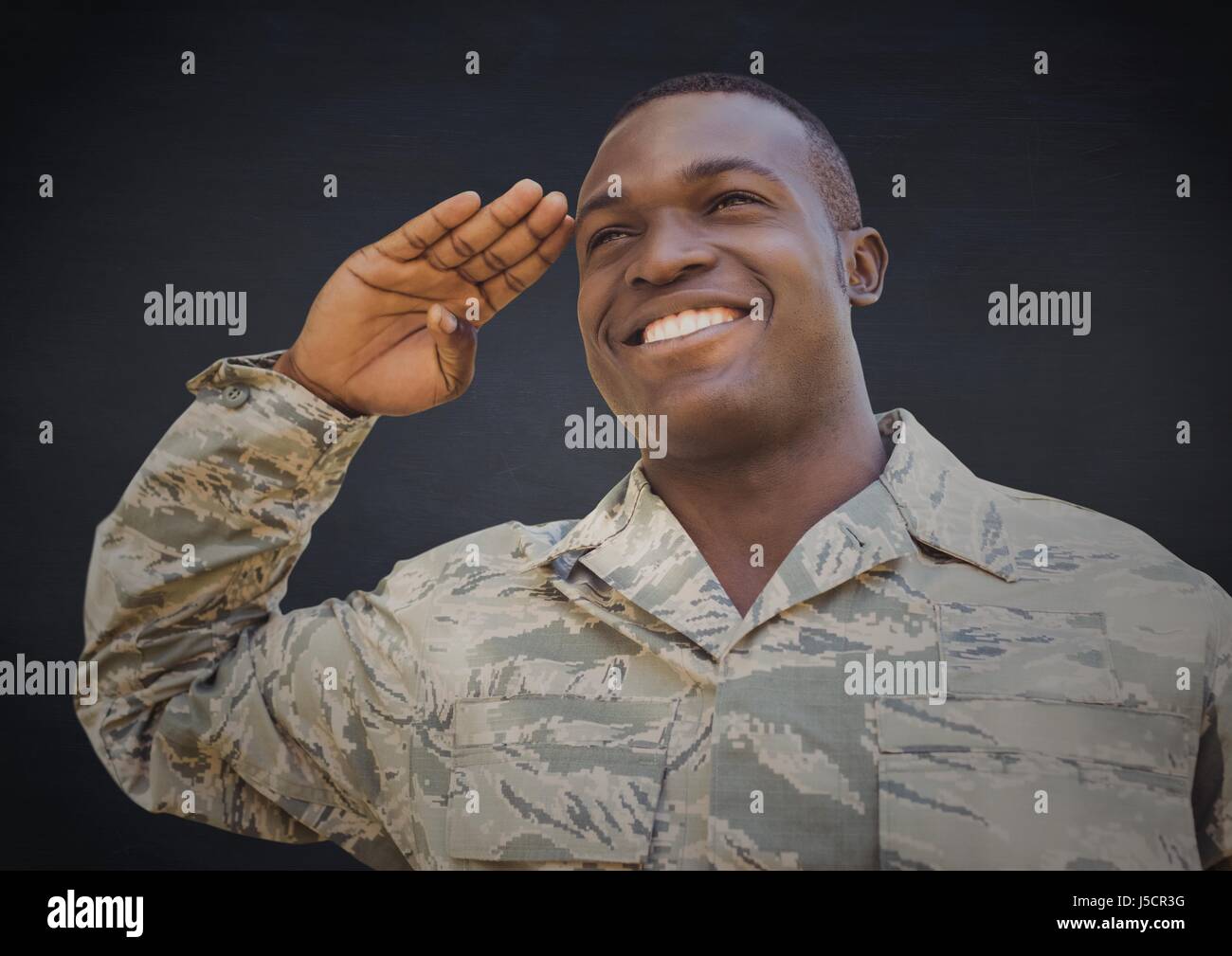Digital composite of Soldier smiling and saluting against navy ...