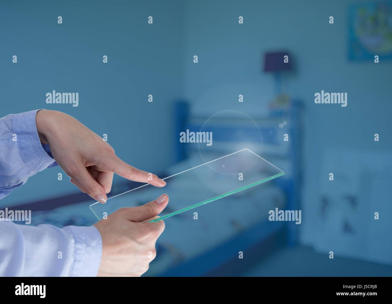 Digital composite of Hand Touching Glass screen in children's bedroom ...