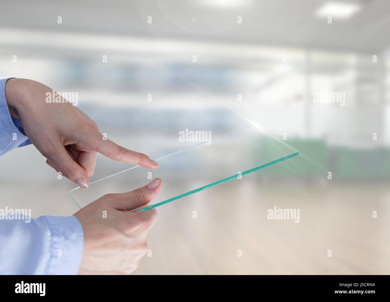 Digital composite of Hand Touching Glass Screen with bright background ...