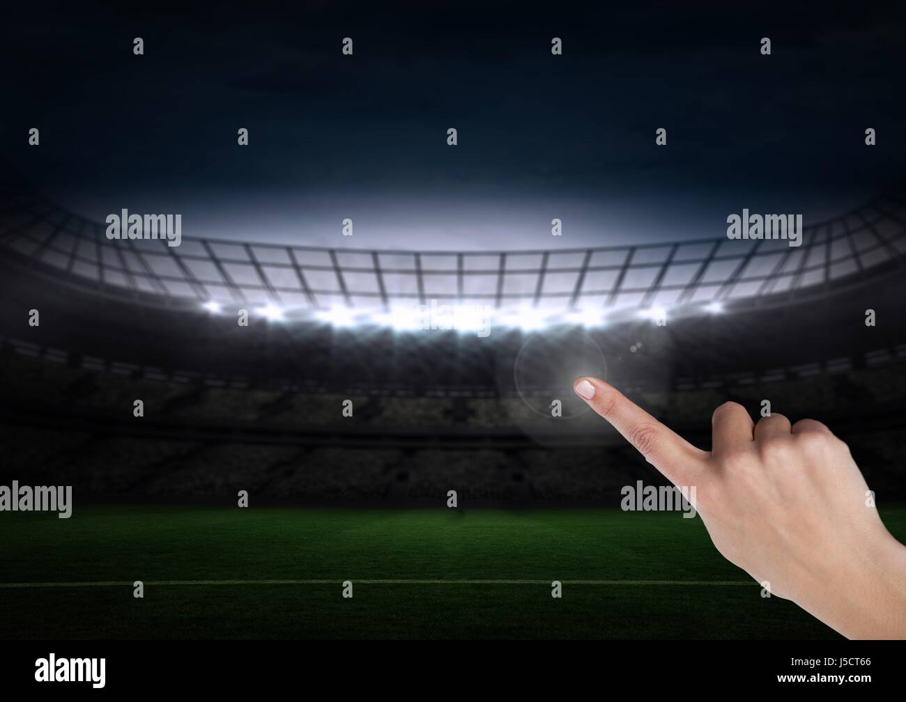 Digital composite of Hand touching sports stadium Stock Photo - Alamy