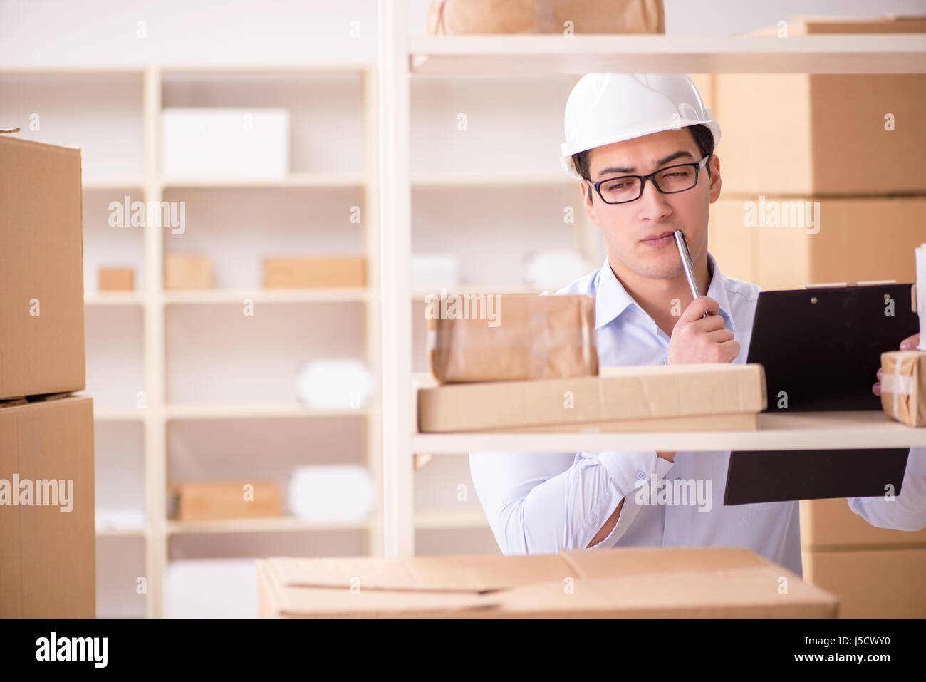 Man working in postal parcel delivery service office Stock Photo - Alamy
