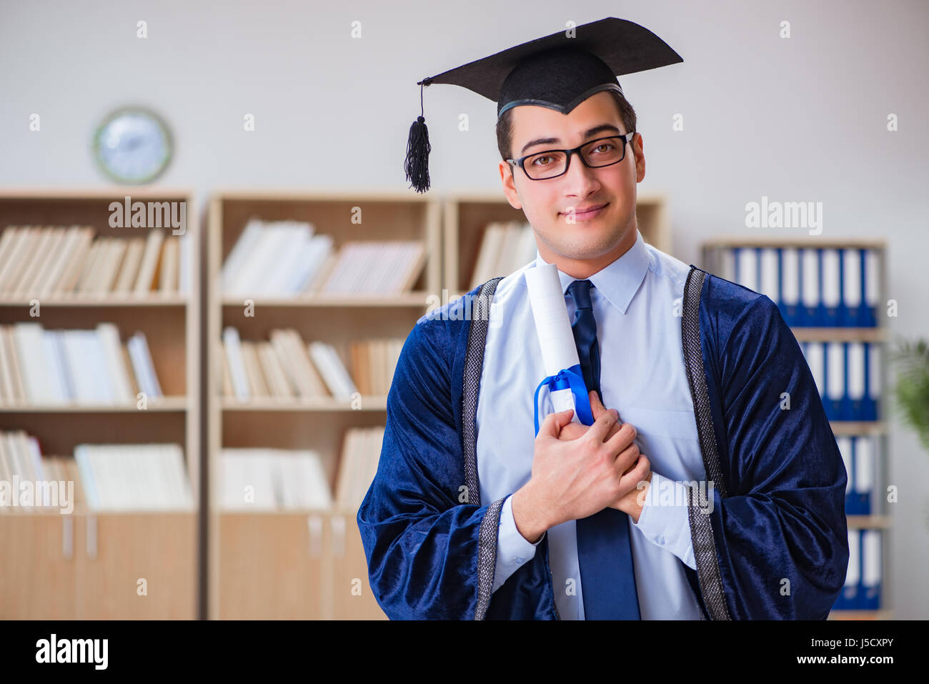 Young man graduating from university Stock Photo - Alamy