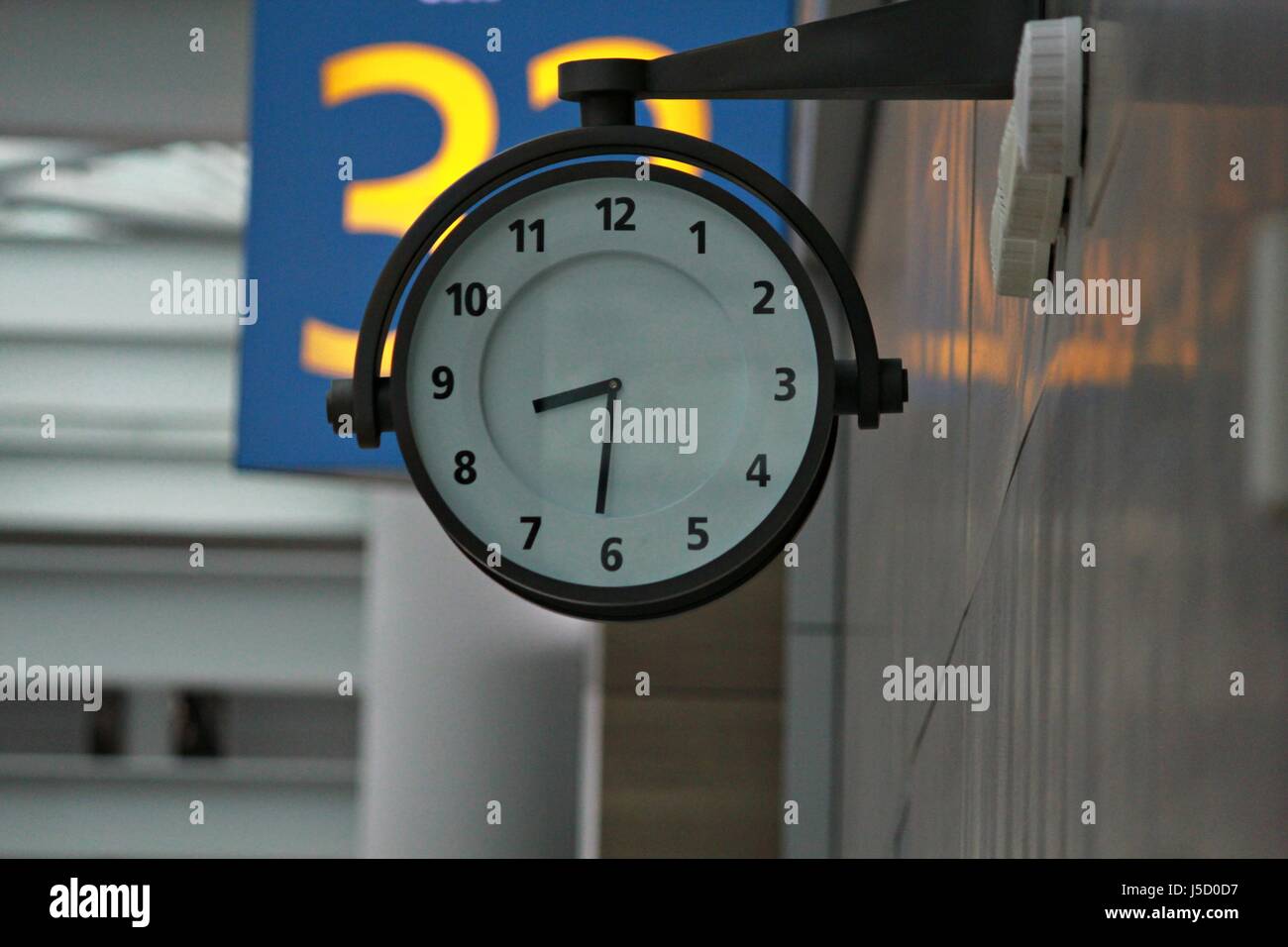 A huge white wall clock displayed at the airports help passengers track ...