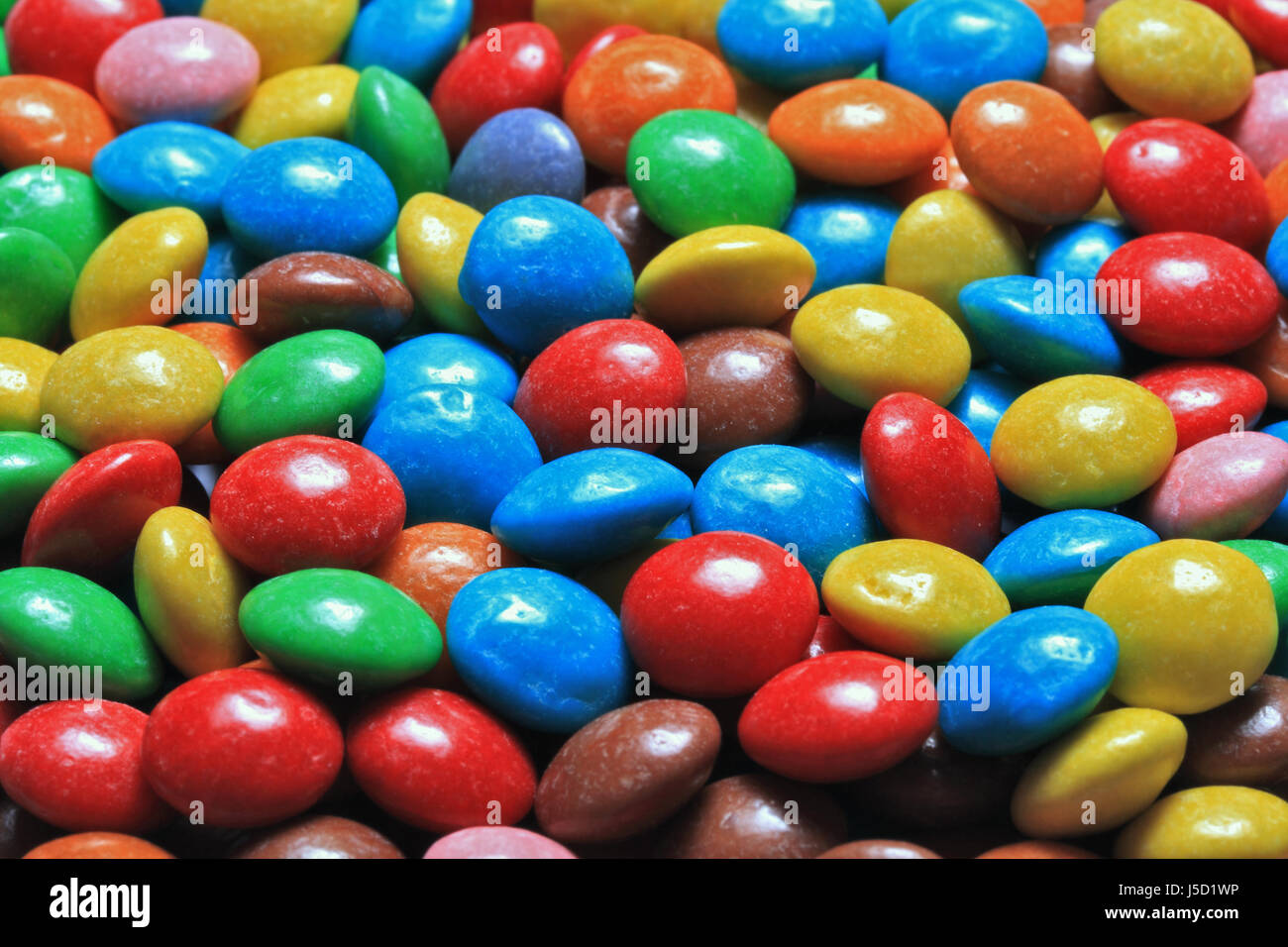 Bright multi-colour chocolates in sugar glaze close-up Stock Photo - Alamy