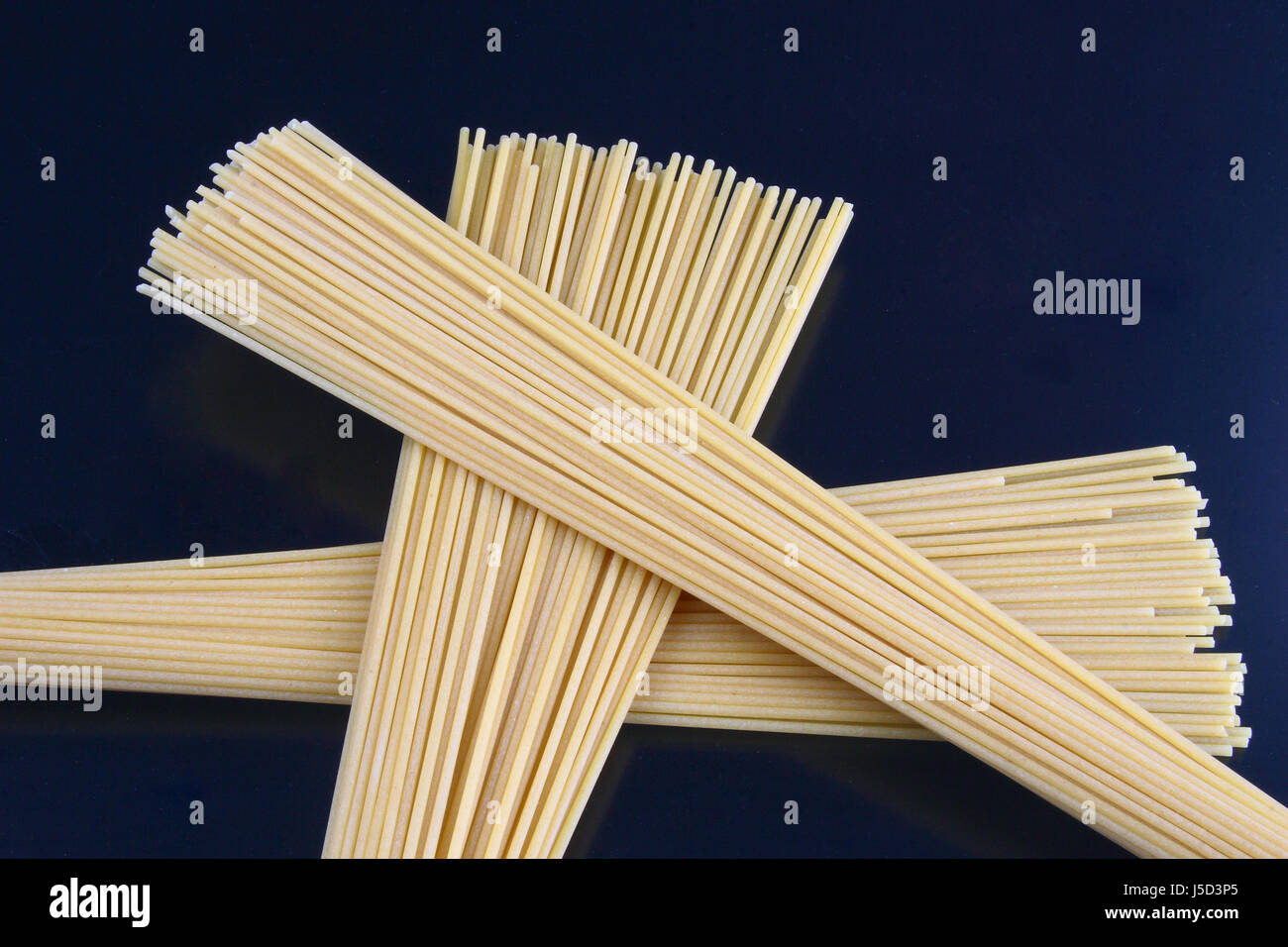 three bundles of spaghetti Stock Photo - Alamy