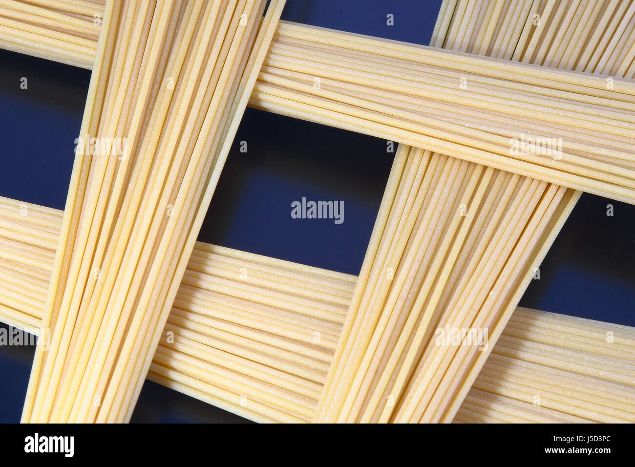 four bundles of spaghetti Stock Photo - Alamy