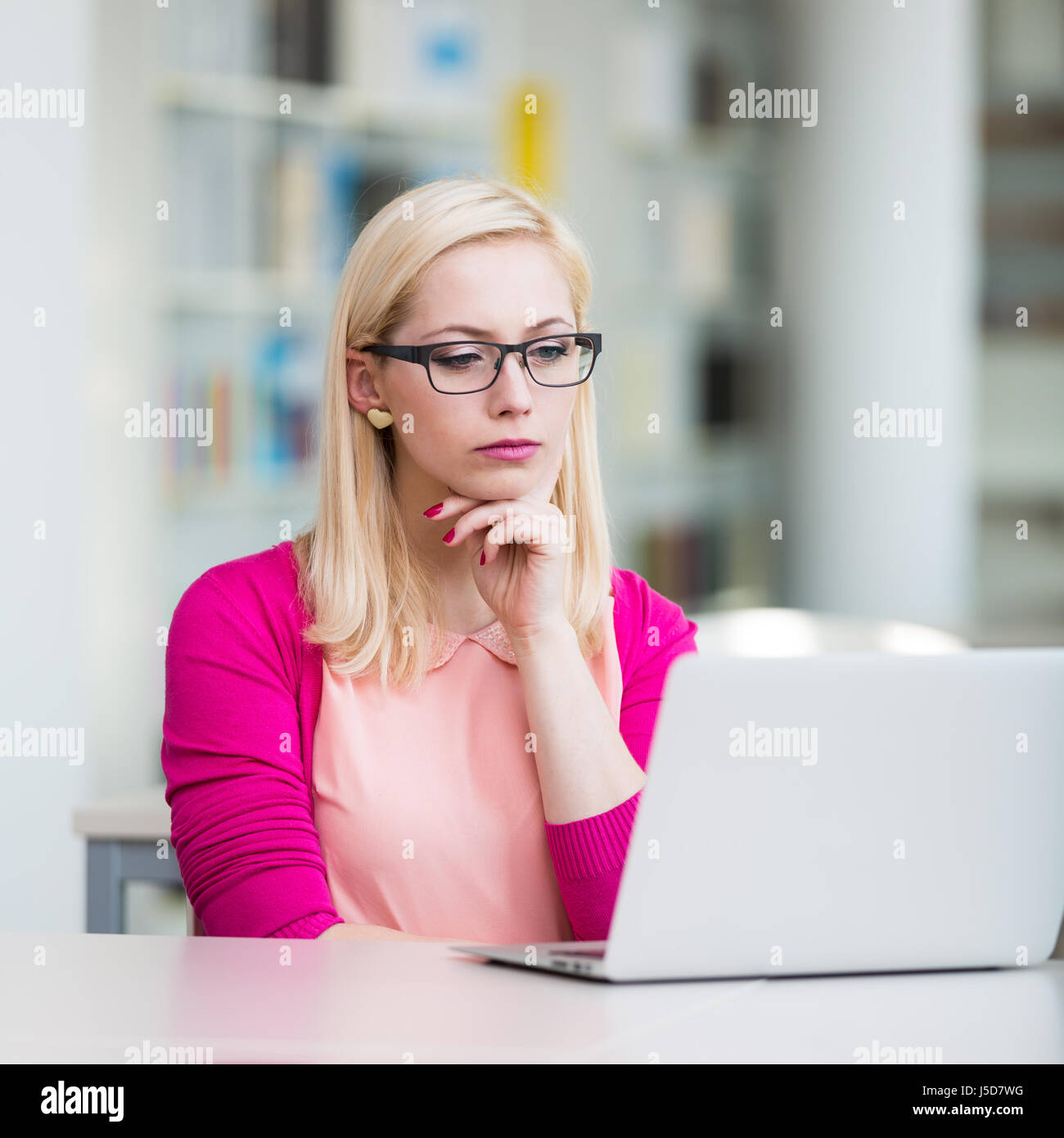 Pretty young college student in a library (shallow DOF; color toned ...
