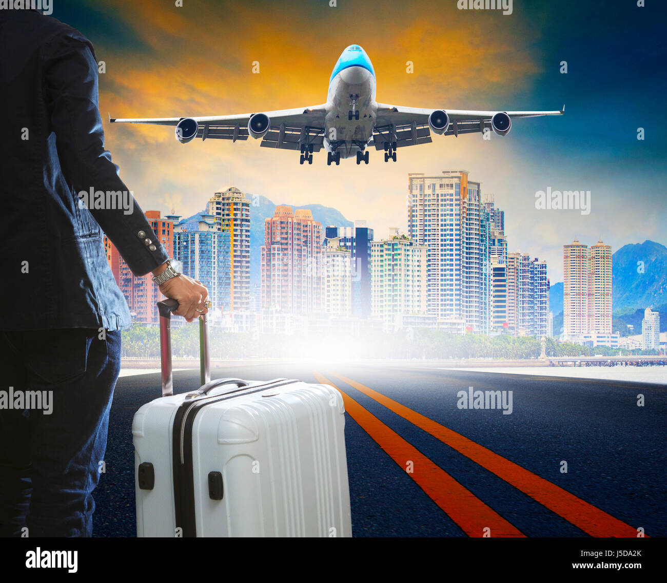business man and luggage standing on airport runways with passenger jet ...