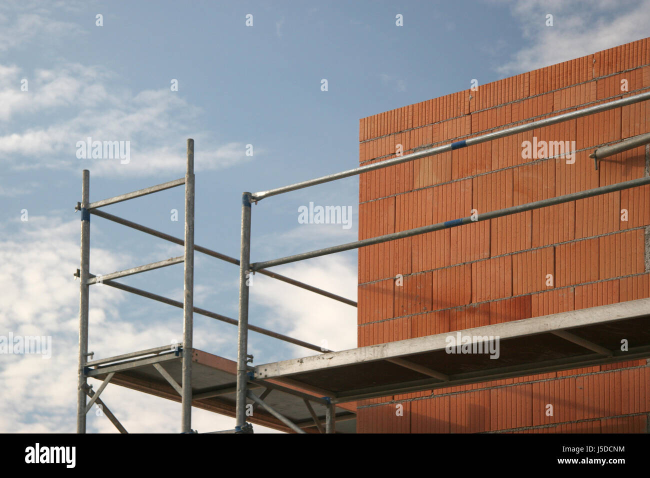 blue house building brick scaffold scaffolding specific land-use area ...