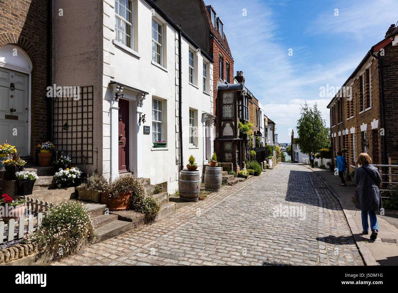Visitors walk past the pretty cottages on the High Street at Upnor on ...
