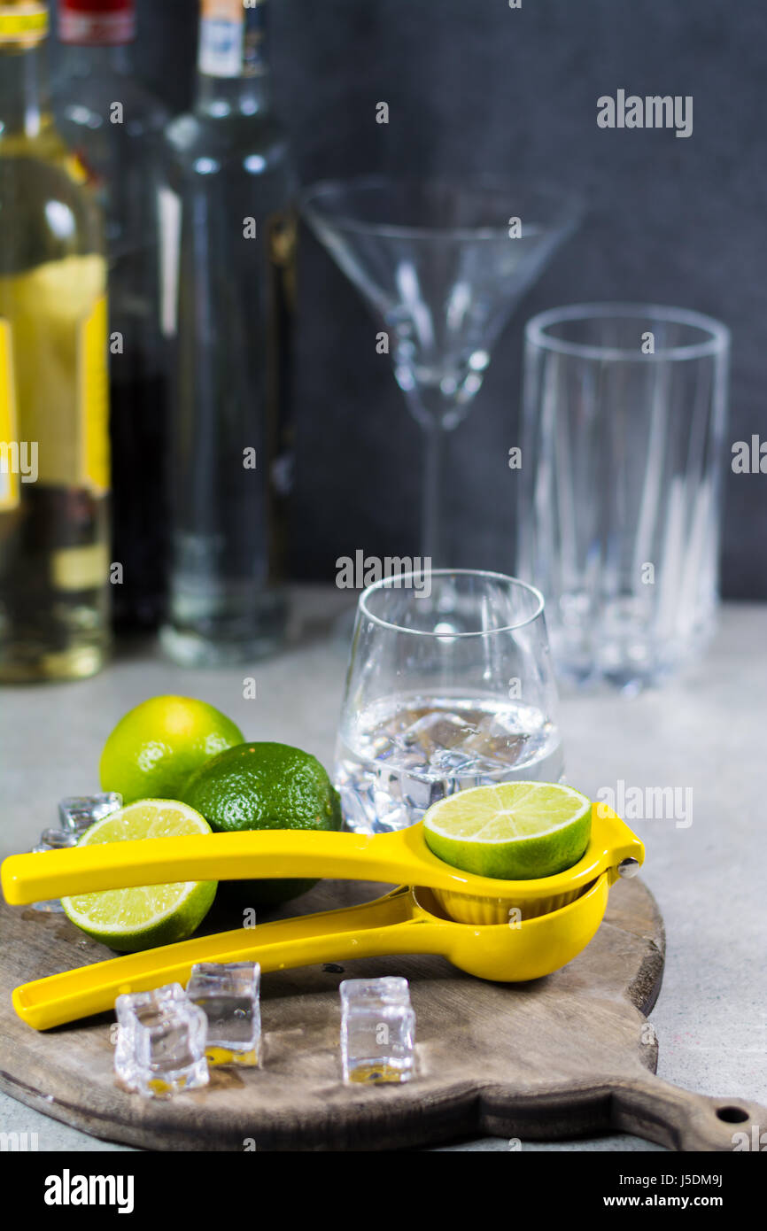 Lime manual squeezer for of cocktails, glass with ice cubes, party time ...