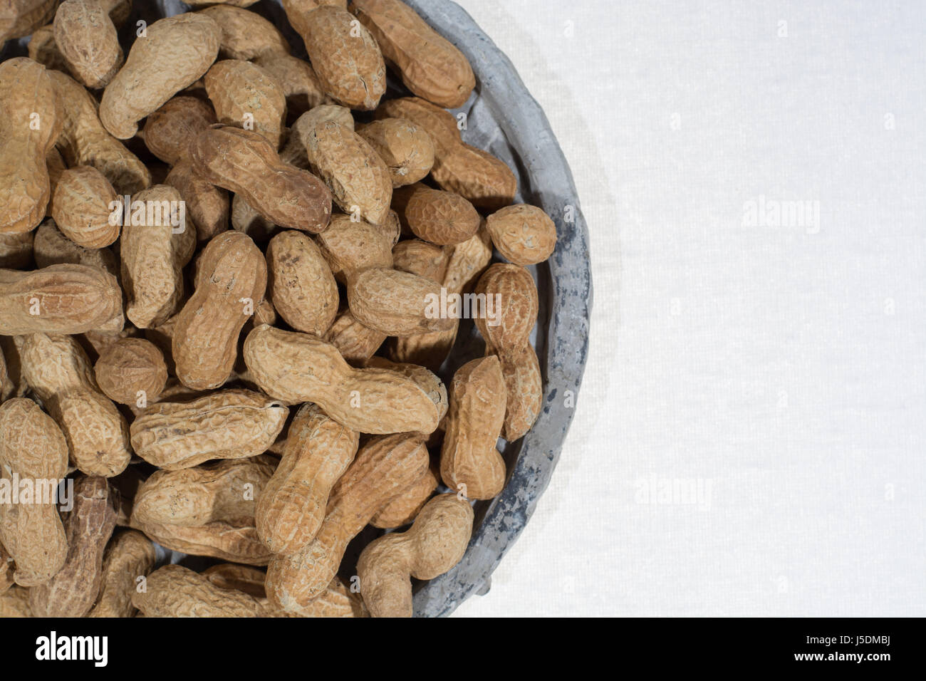 Peanuts in shell on the grey pate, white backgound, copy space Stock ...