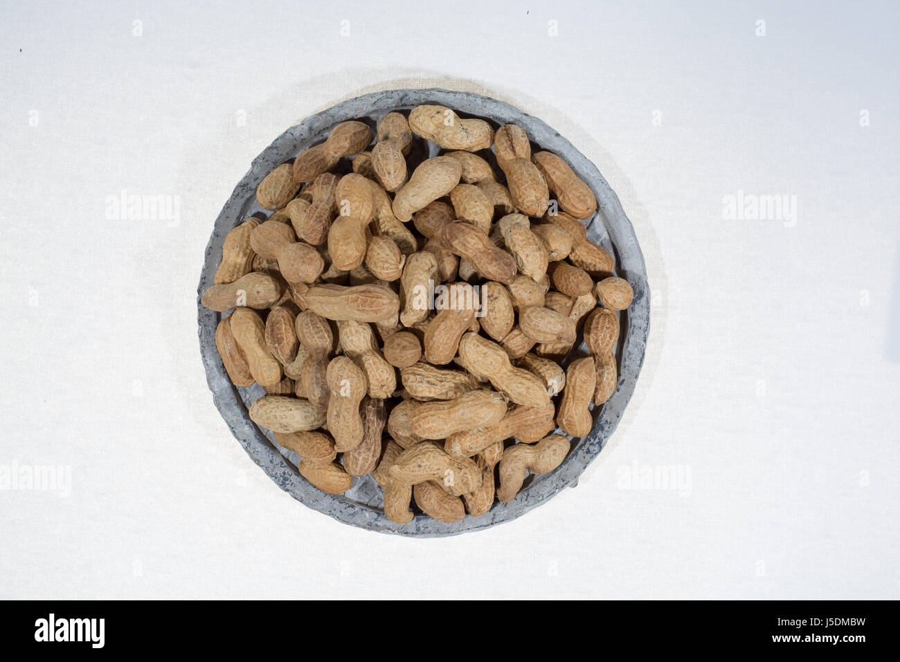 Peanuts in shell on the grey pate, white backgound, copy space Stock ...