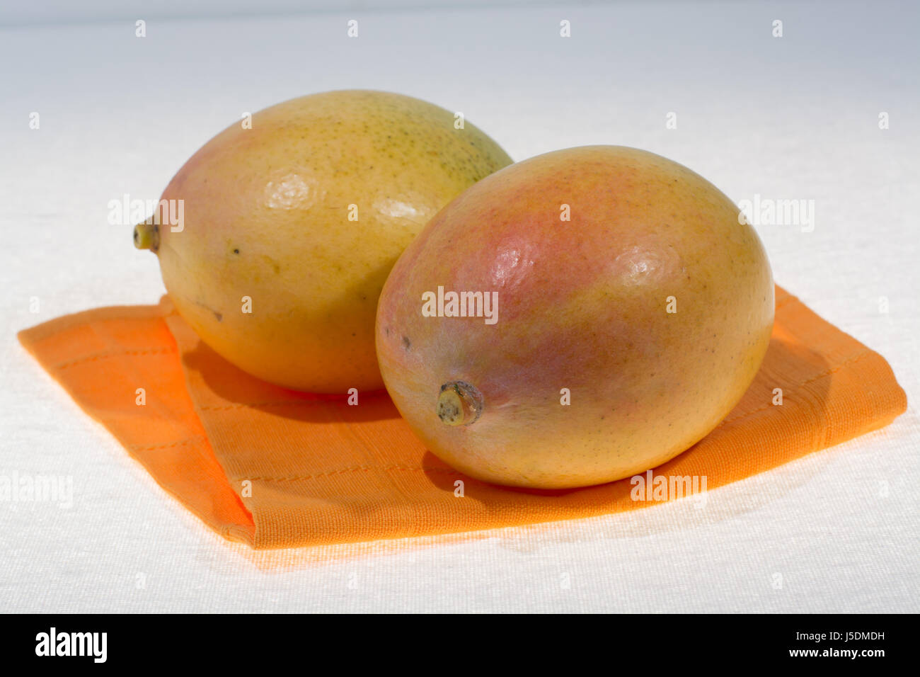 Two ripe organic golden yellow mangoes ready to eat close up Stock ...