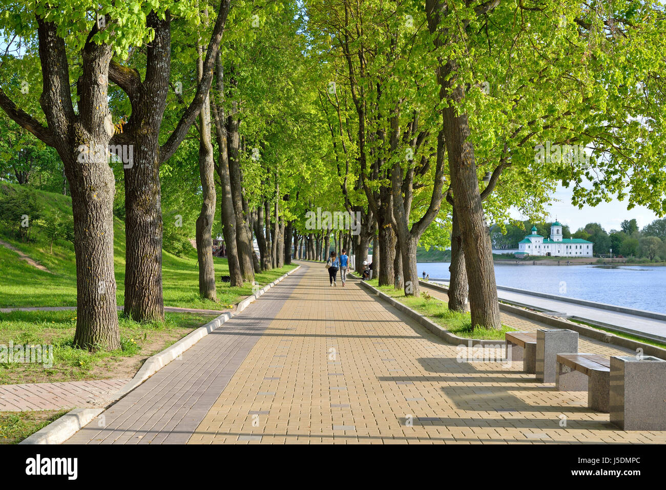 A couple of passersby on the walk of the embankment of the river great ...
