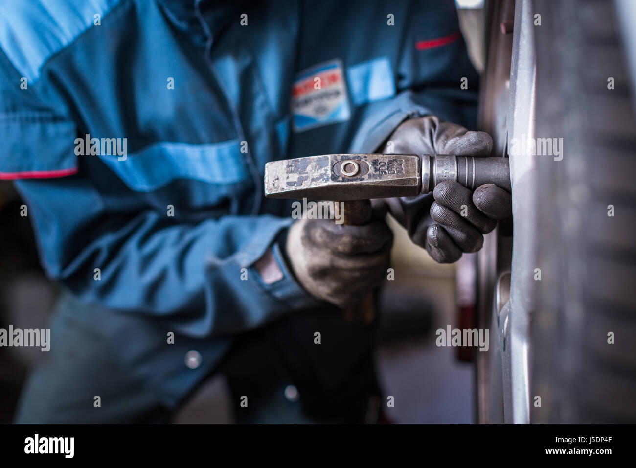 mechanic changing a wheel of a modern car (color toned image Stock ...