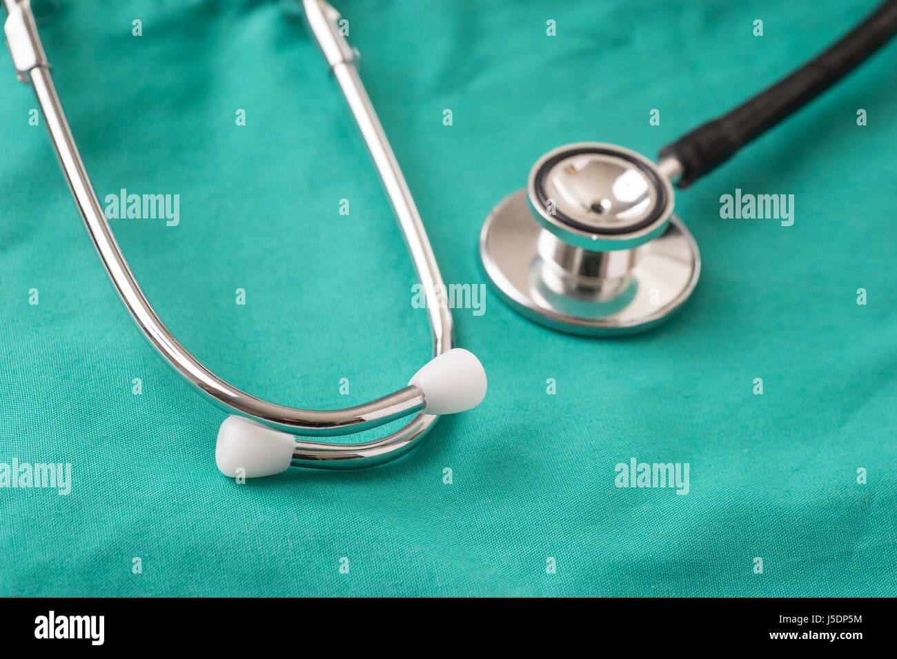 Medical Stethoscope lying on the hospital's green background. The ...