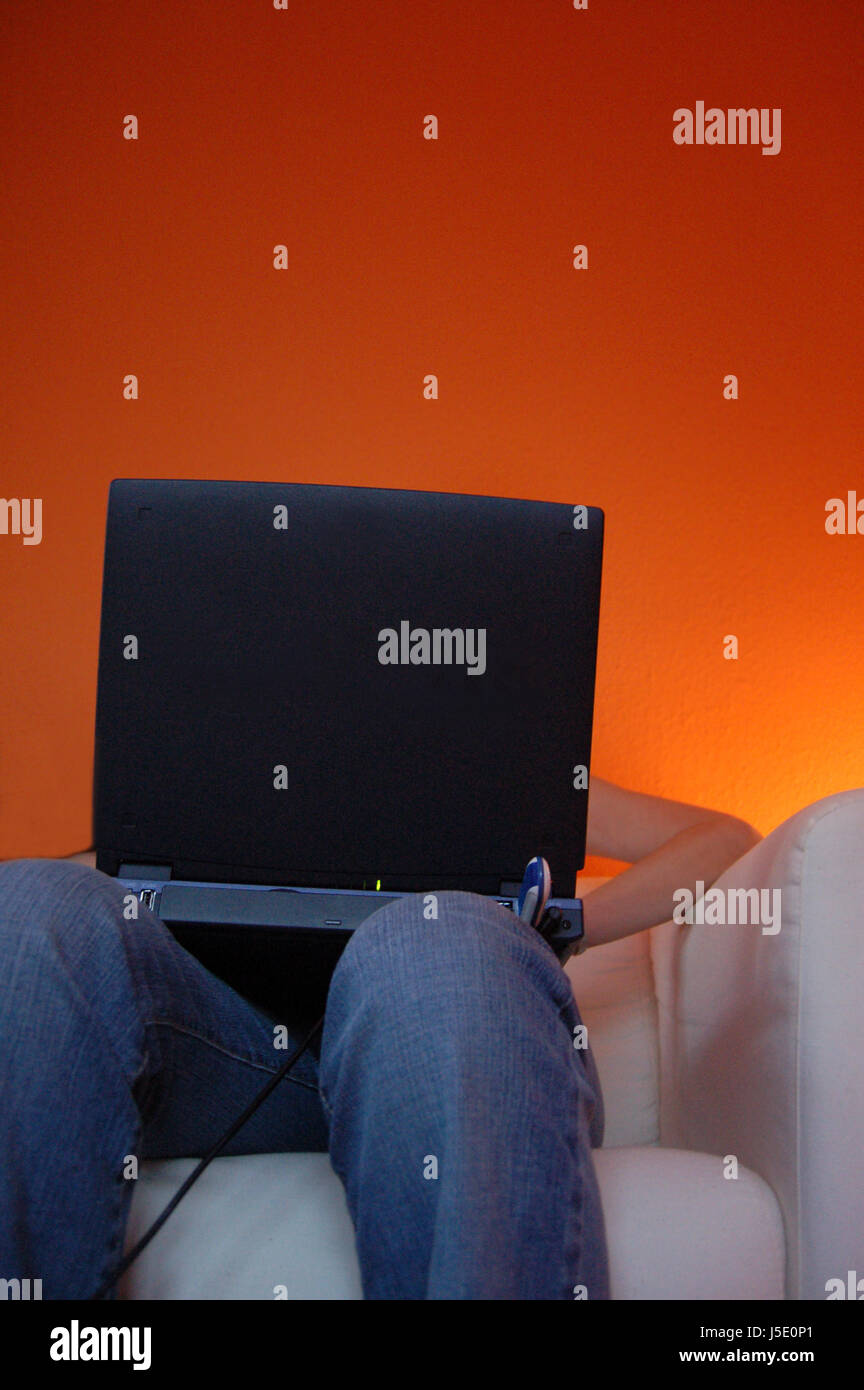 woman legs laptop notebook computers computer PC at home jeans trousers ...