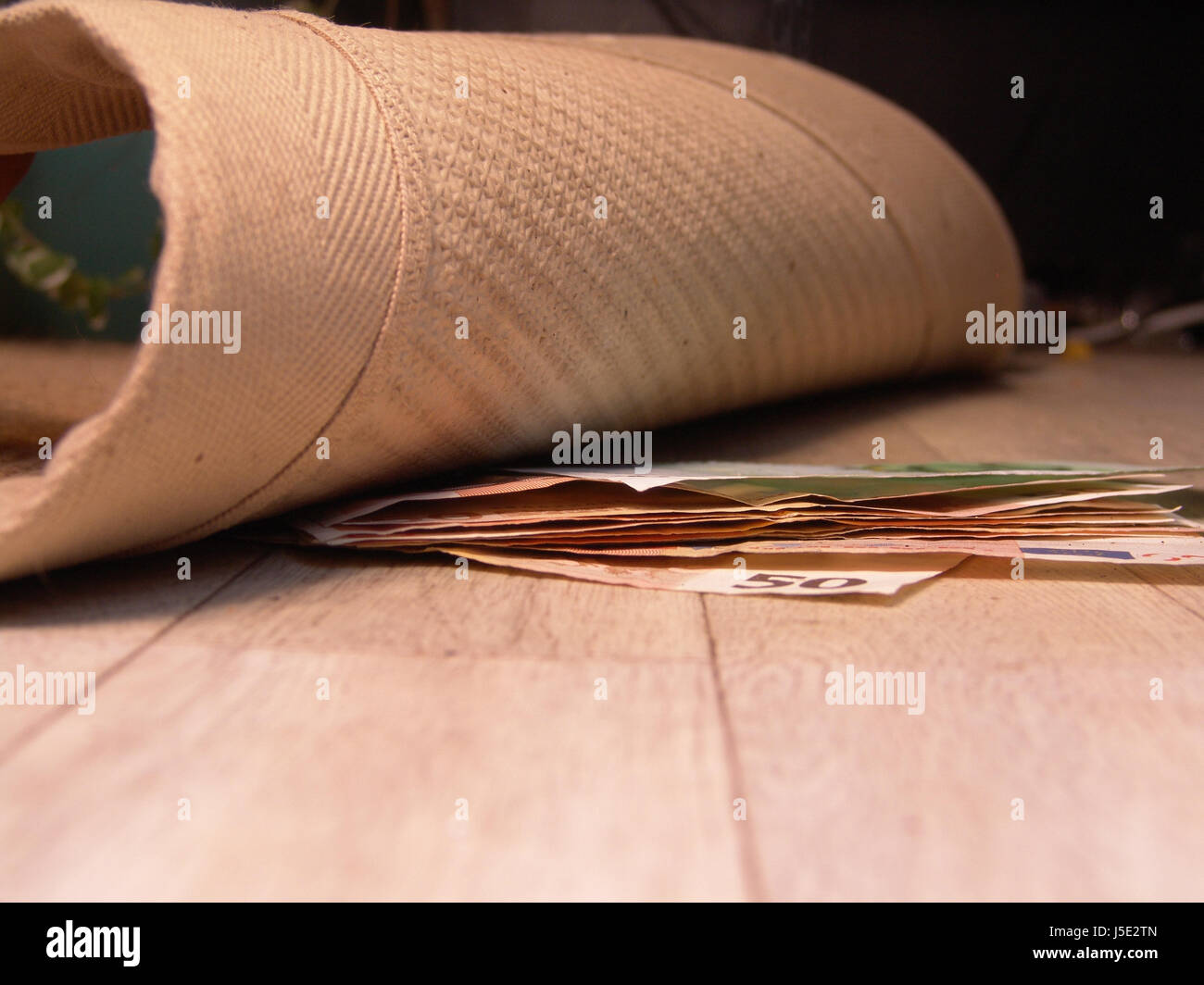 money under carpet Stock Photo - Alamy