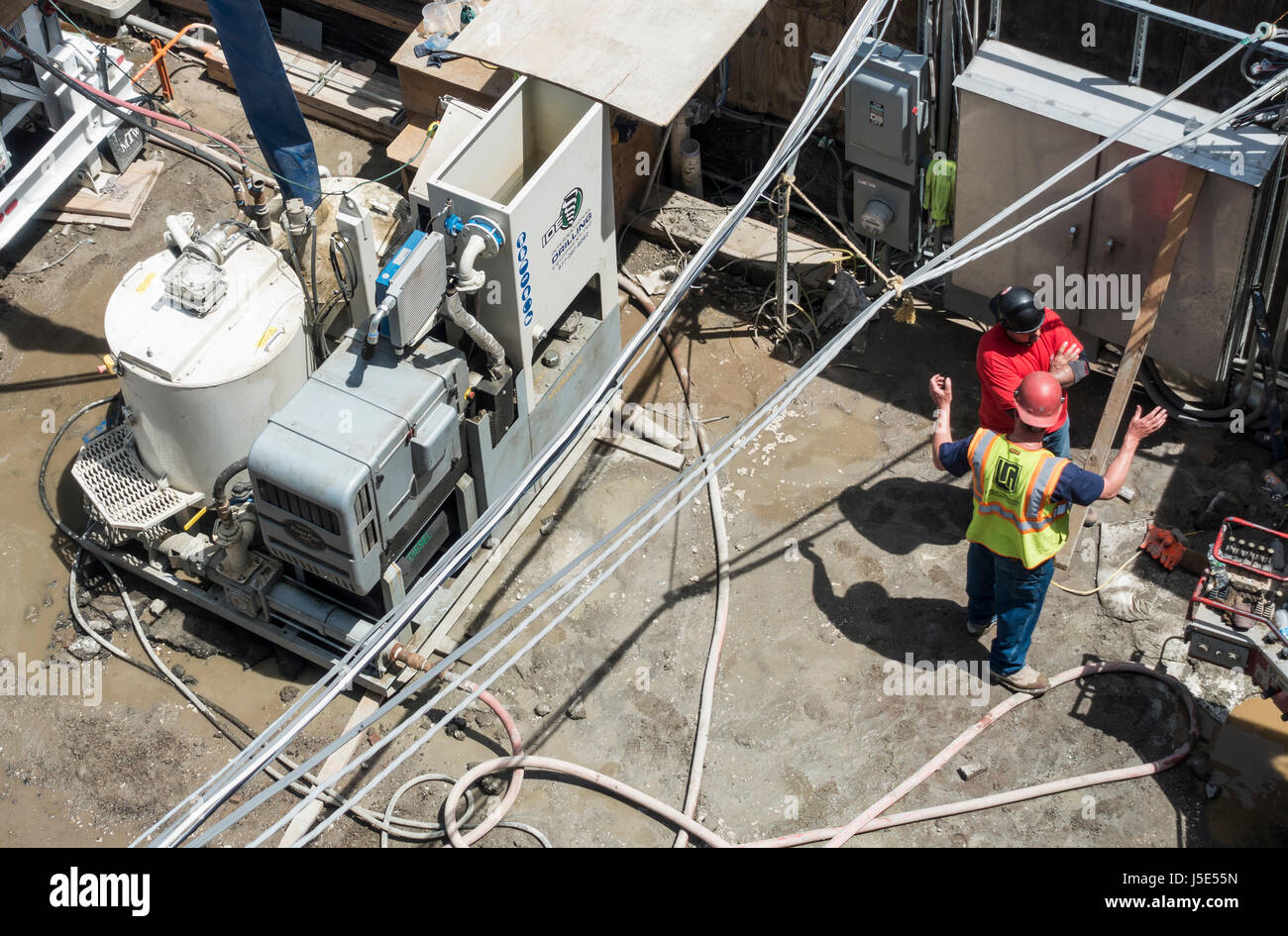 Two construction workers in conversation at a work site in Chelsea, New ...