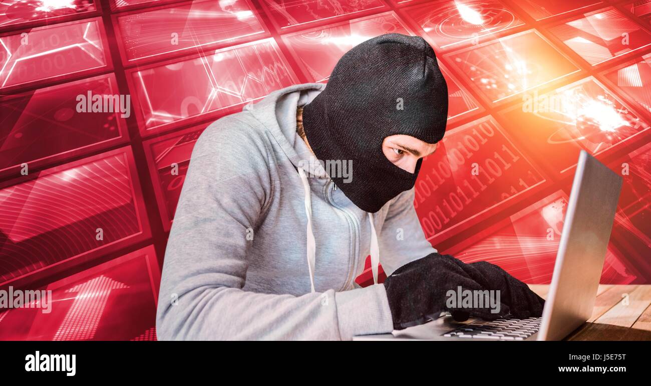 Digital composite of Hacker wearing monkey cap while using laptop Stock ...