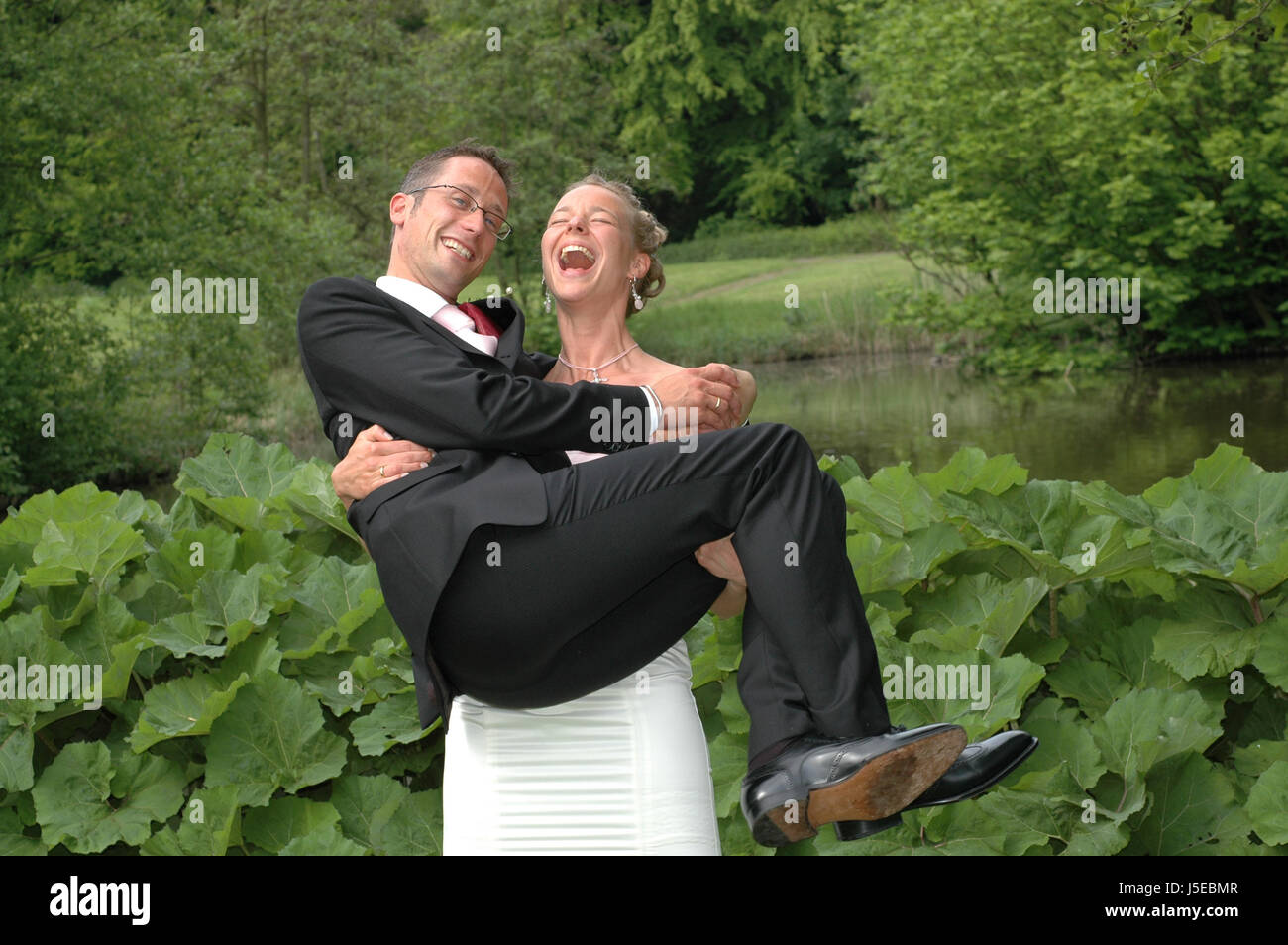 bride carrying groom Stock Photo - Alamy