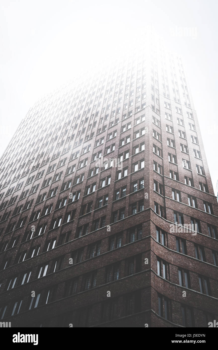 high rise building facade in misty fog - brick skyscraper Stock Photo ...