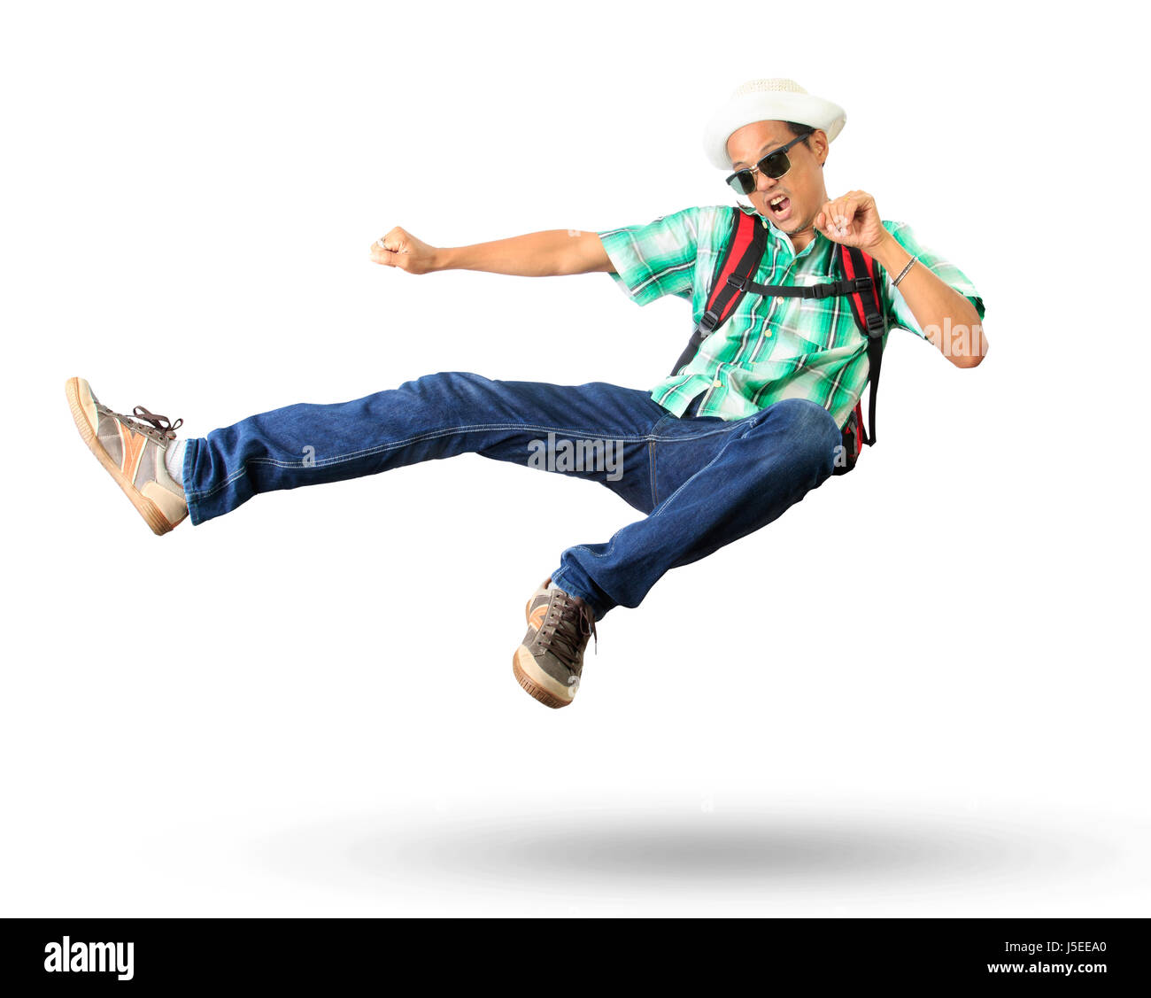 young man with back pack sky kick jumping action isolated white ...