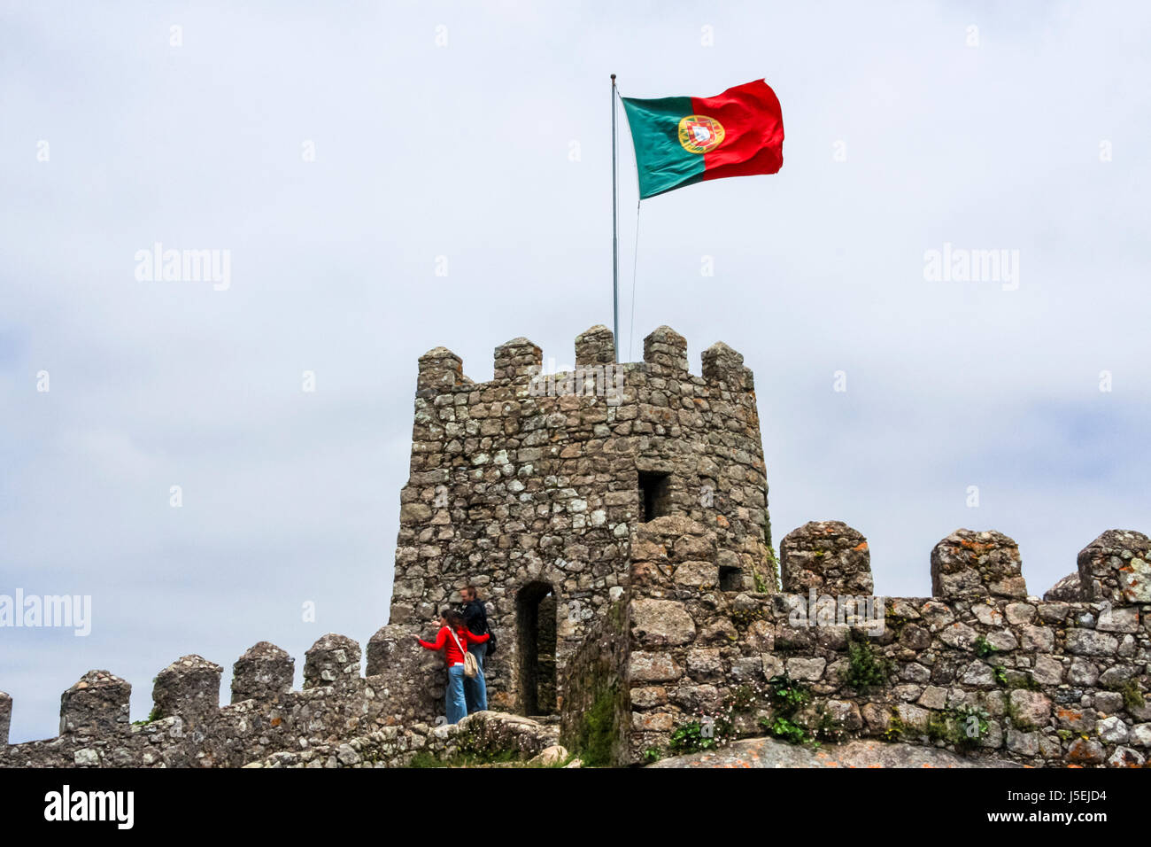 Portugal flag fluttering in wind on mast of tower of the Moorish Castle ...