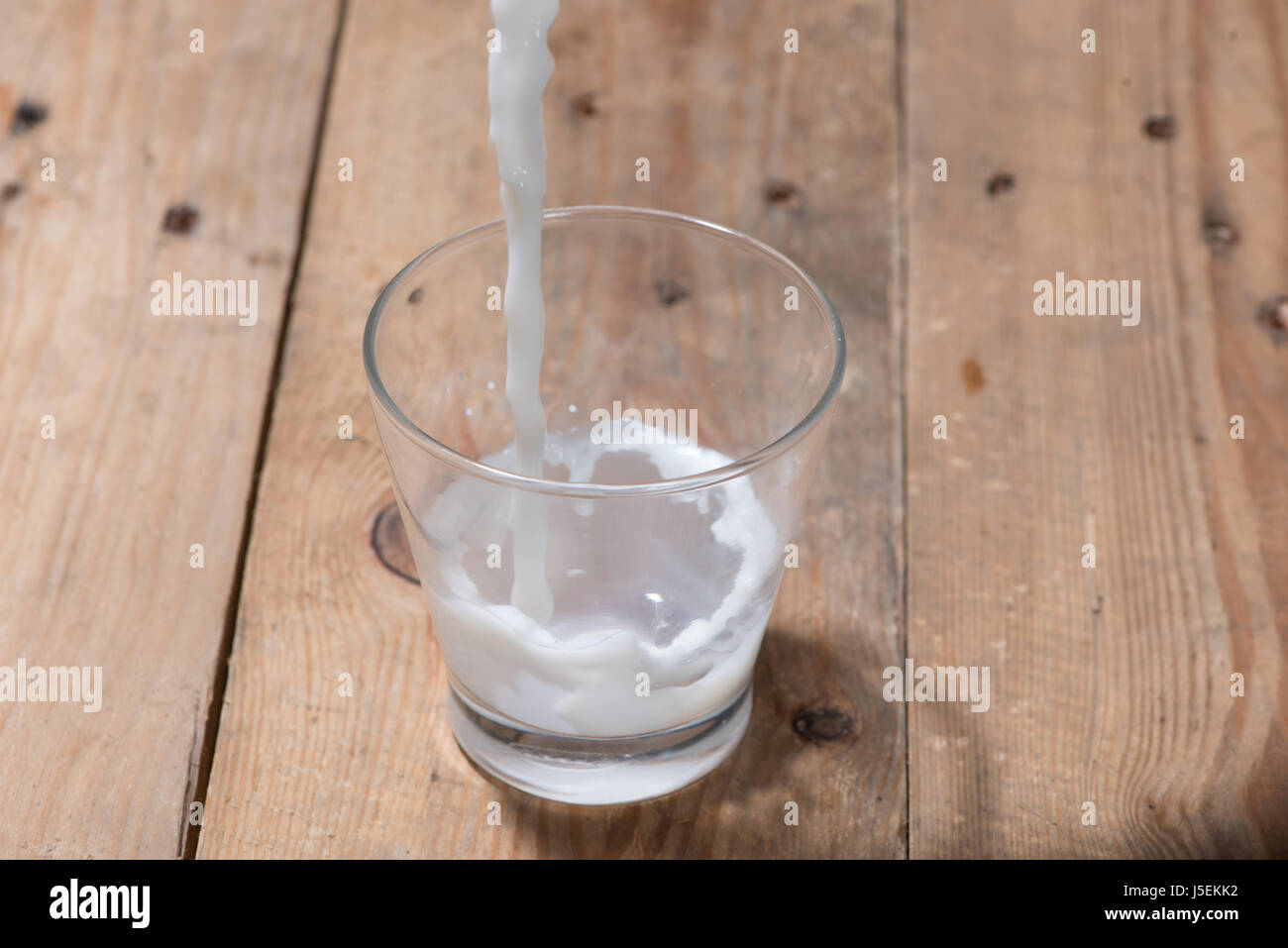 Milk. Image of Milk fall into glass Stock Photo - Alamy