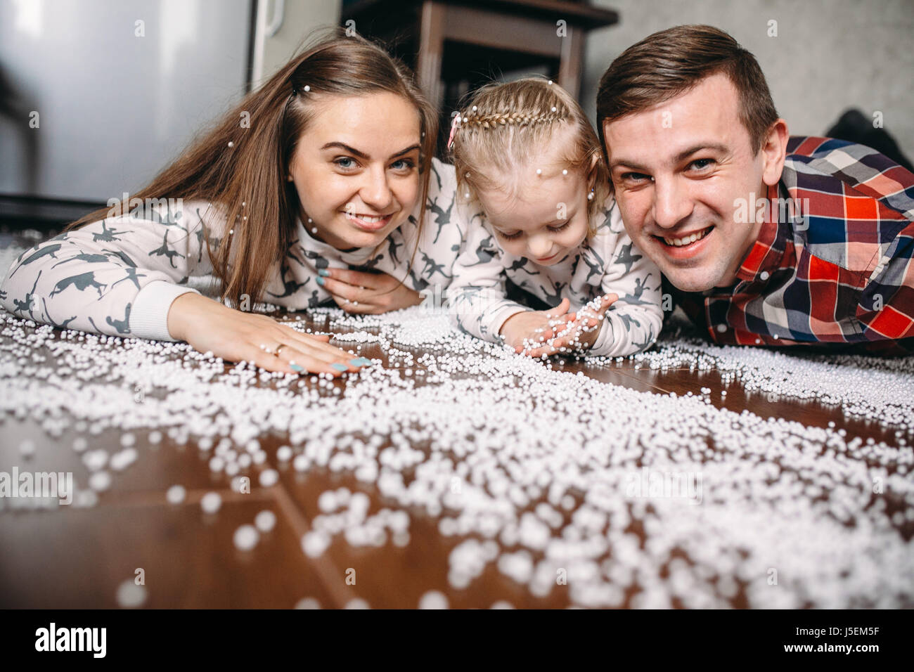Happy family playing together on the floor Stock Photo - Alamy