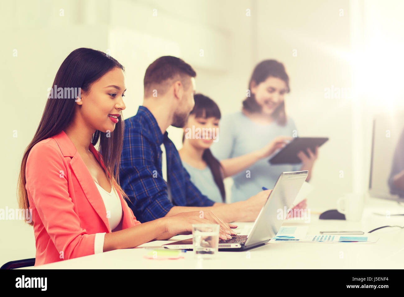 happy african woman over creative team at office Stock Photo - Alamy