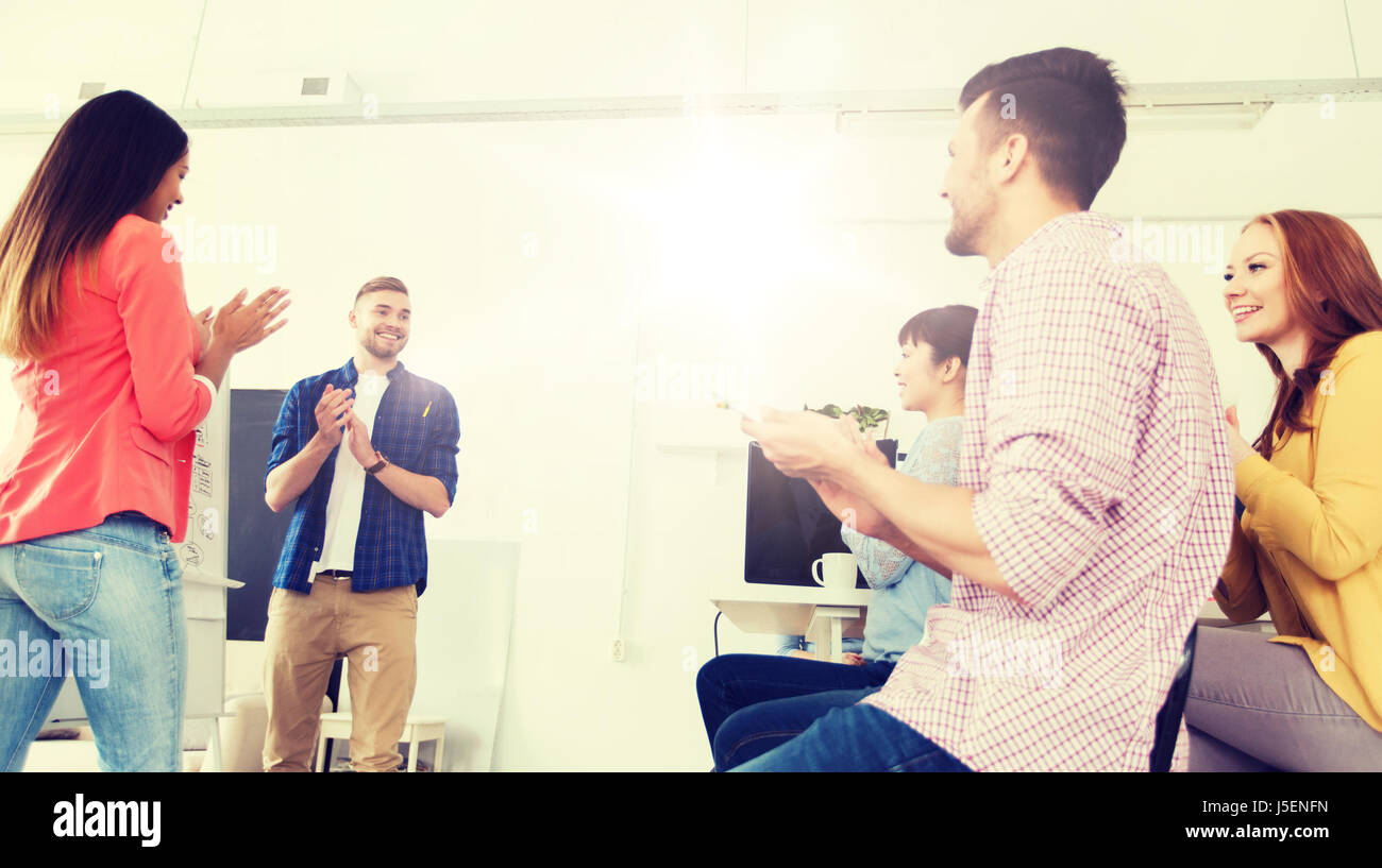 Team celebrating colleague success hi-res stock photography and images ...