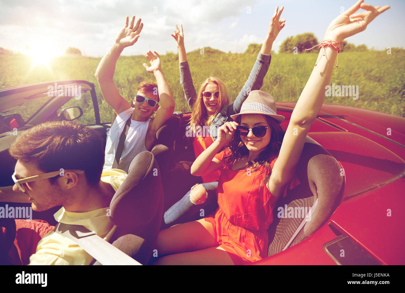happy friends driving in cabriolet car at country Stock Photo - Alamy