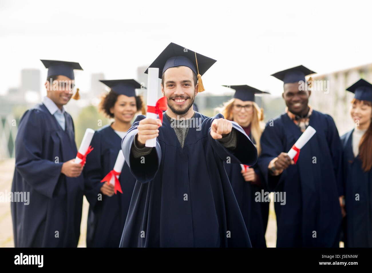 happy student with diploma pointing finger at you Stock Photo - Alamy