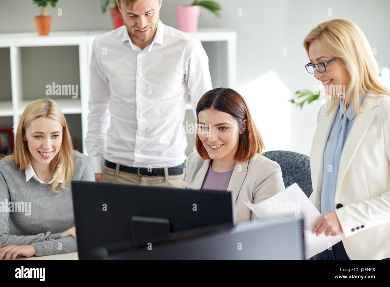 happy business team with computer in office Stock Photo - Alamy