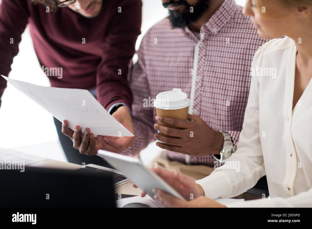 business team with papers and coffee at office Stock Photo - Alamy