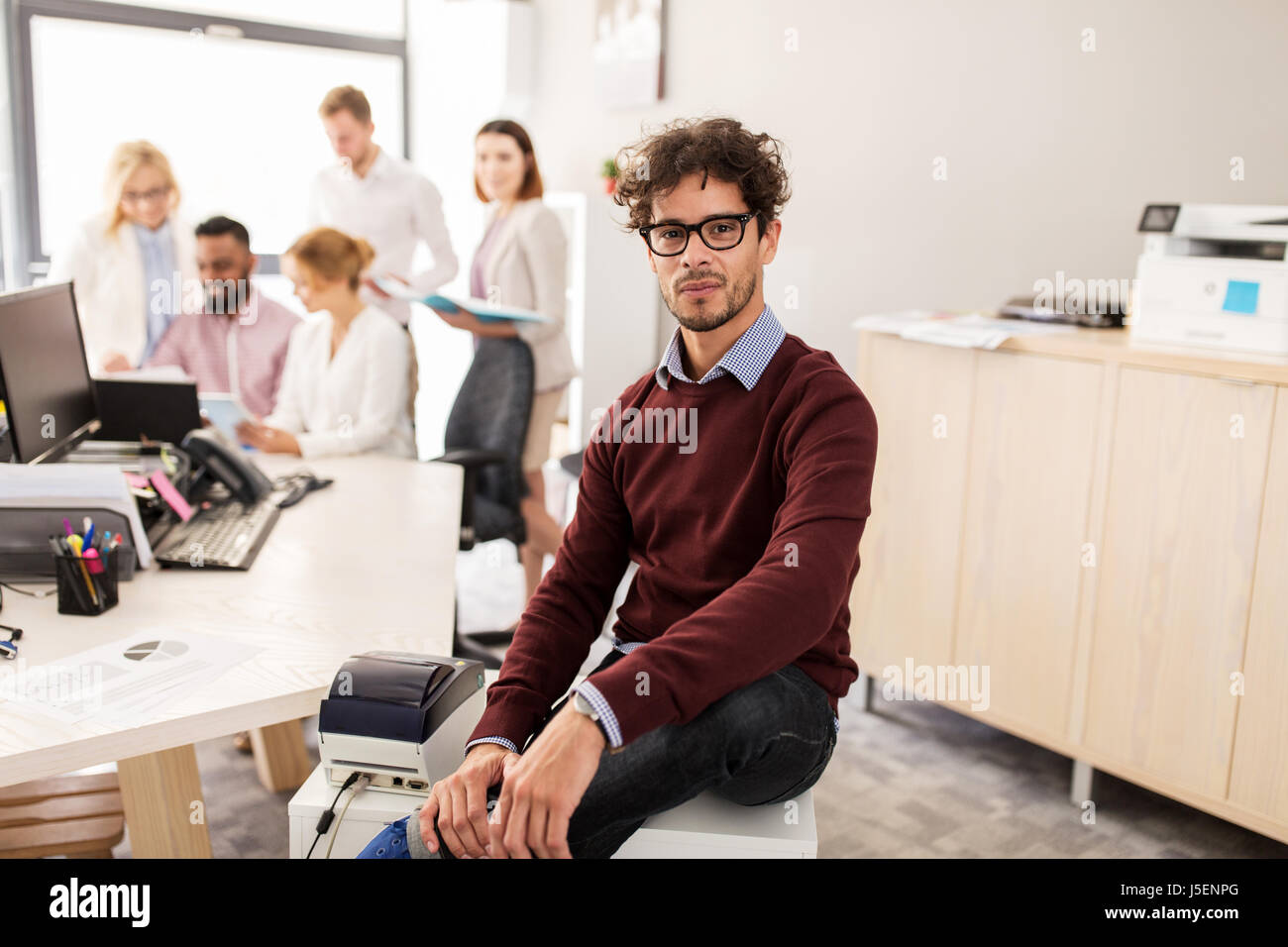 happy young man over creative team in office Stock Photo - Alamy