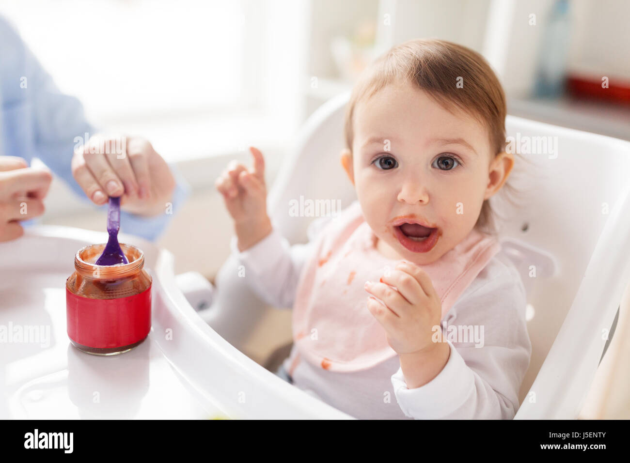 mother feeding baby with puree at home Stock Photo - Alamy