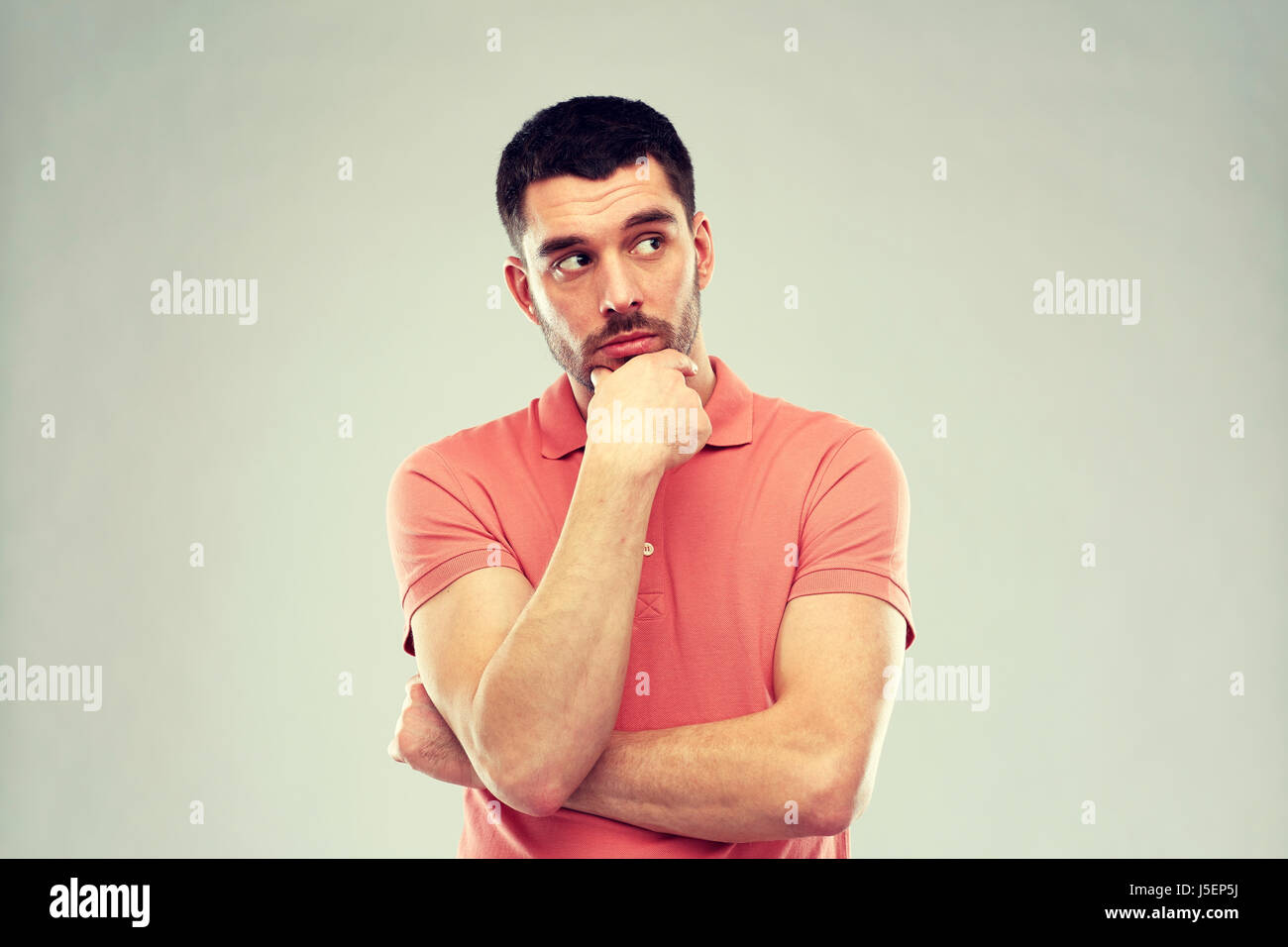 man thinking over gray background Stock Photo - Alamy